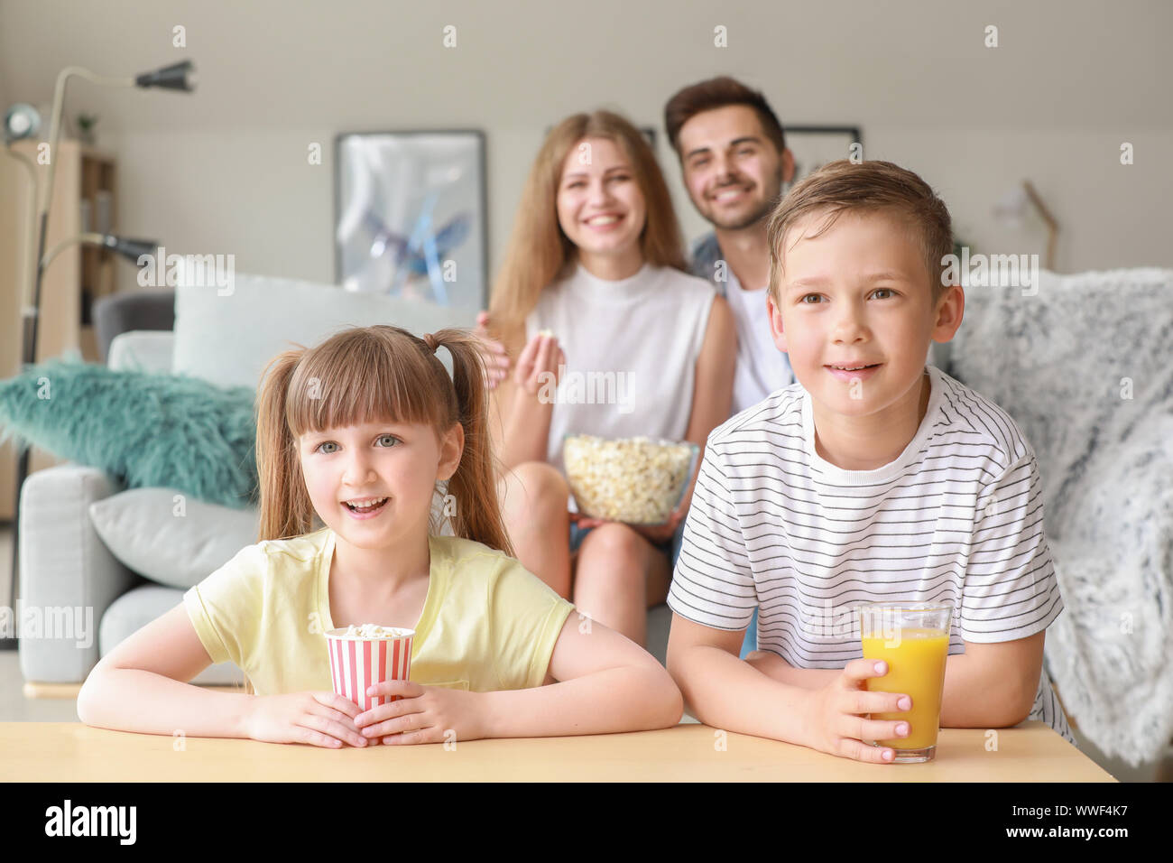 Happy family watching TV at home Stock Photo - Alamy
