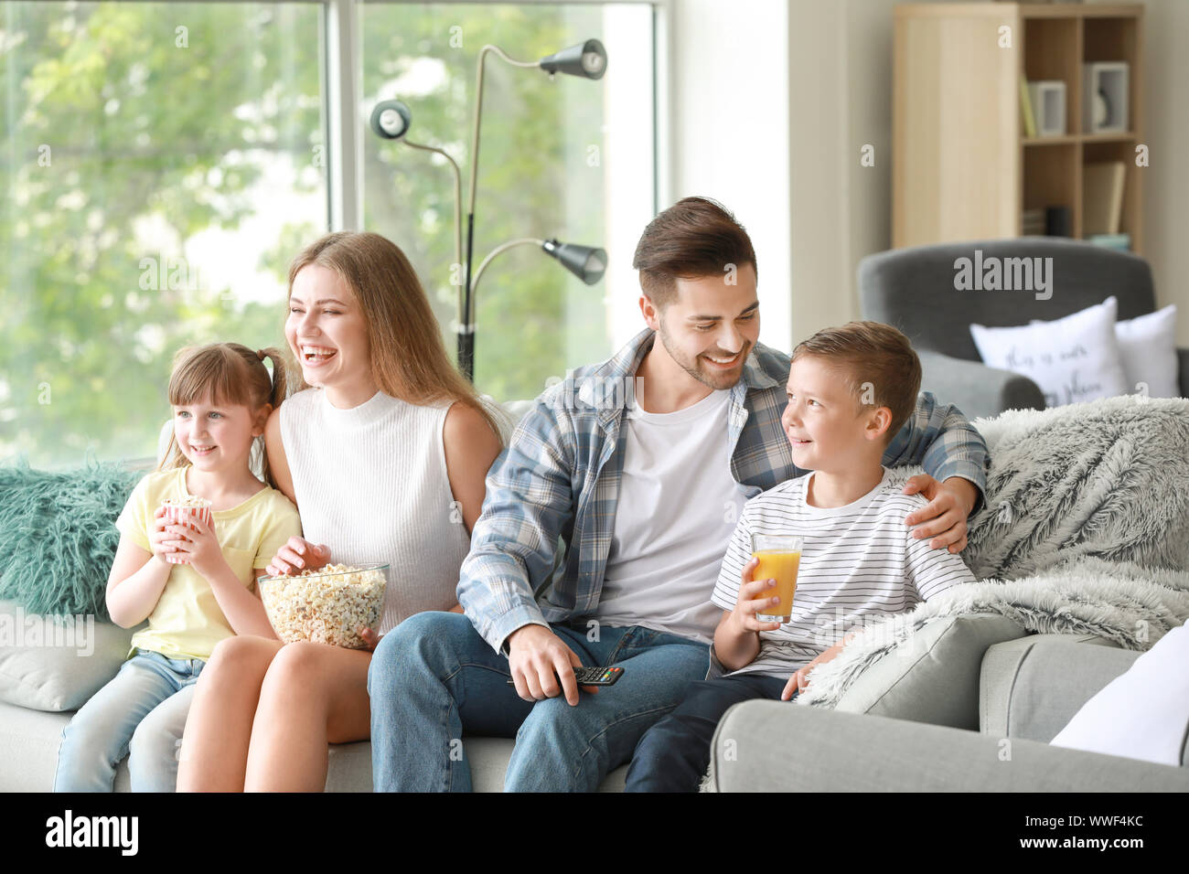 Happy family watching TV at home Stock Photo - Alamy