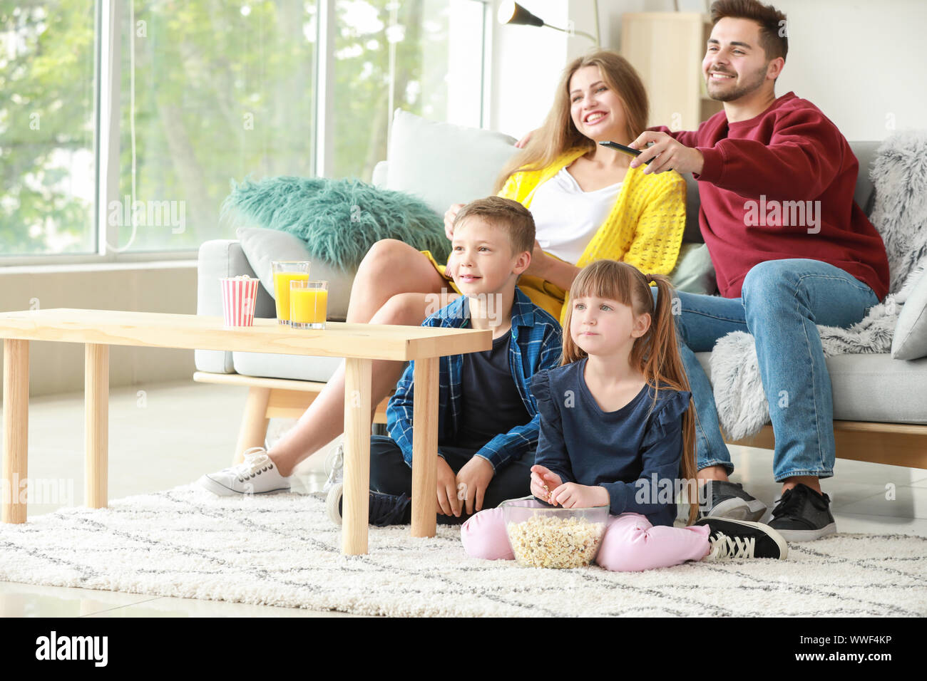 Happy family watching TV at home Stock Photo - Alamy