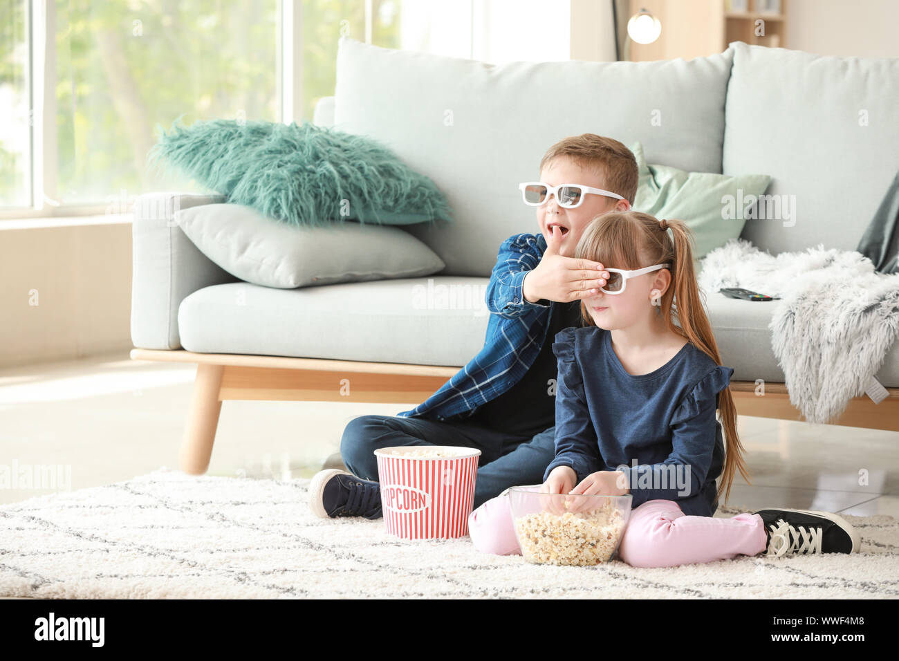 Little children watching scary movie at home Stock Photo - Alamy