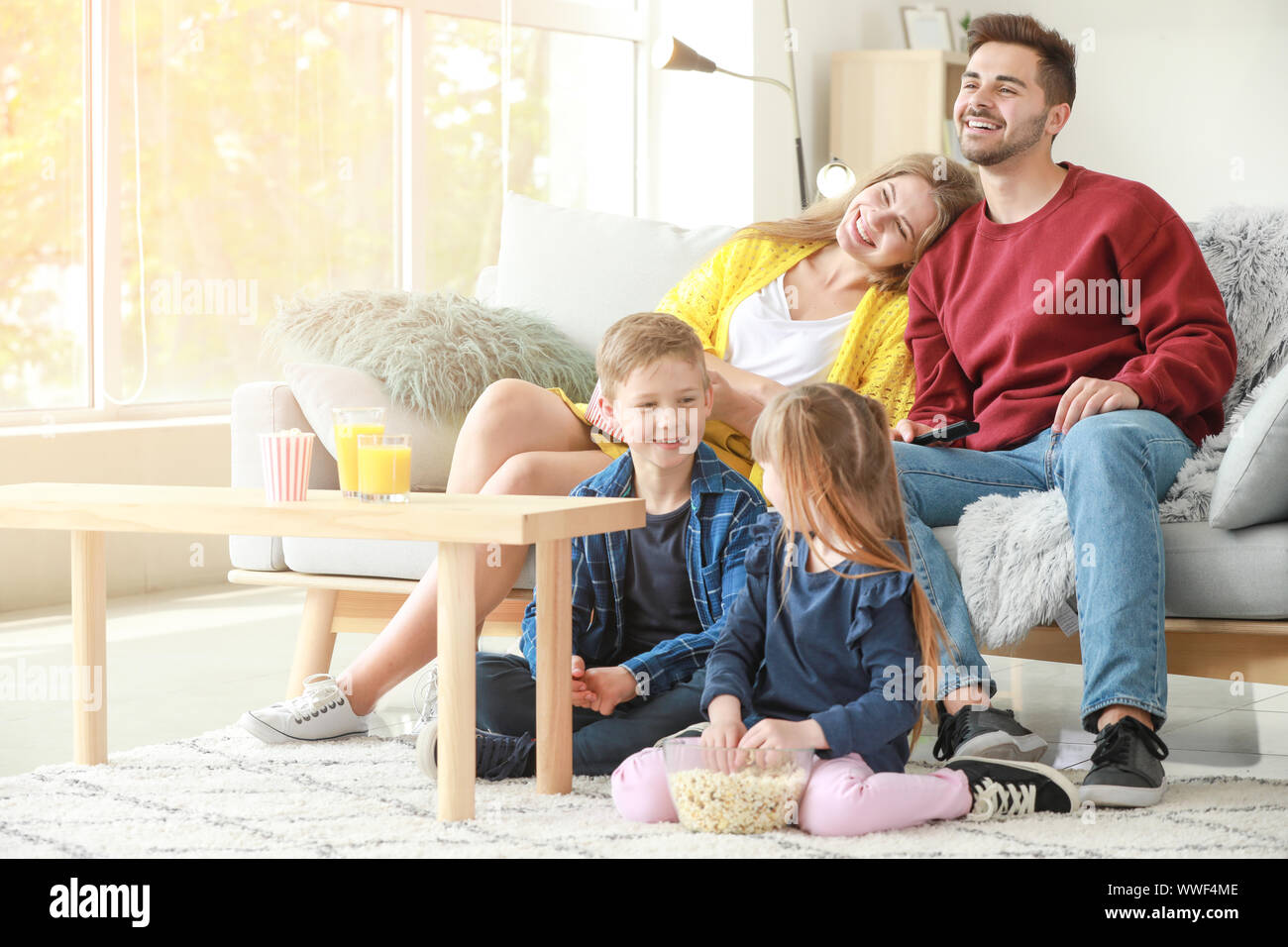 Happy family watching TV at home Stock Photo - Alamy
