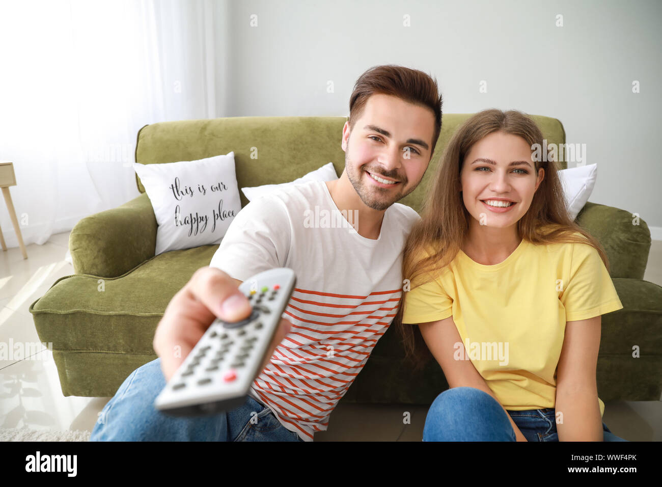 Happy couple watching TV at home Stock Photo - Alamy