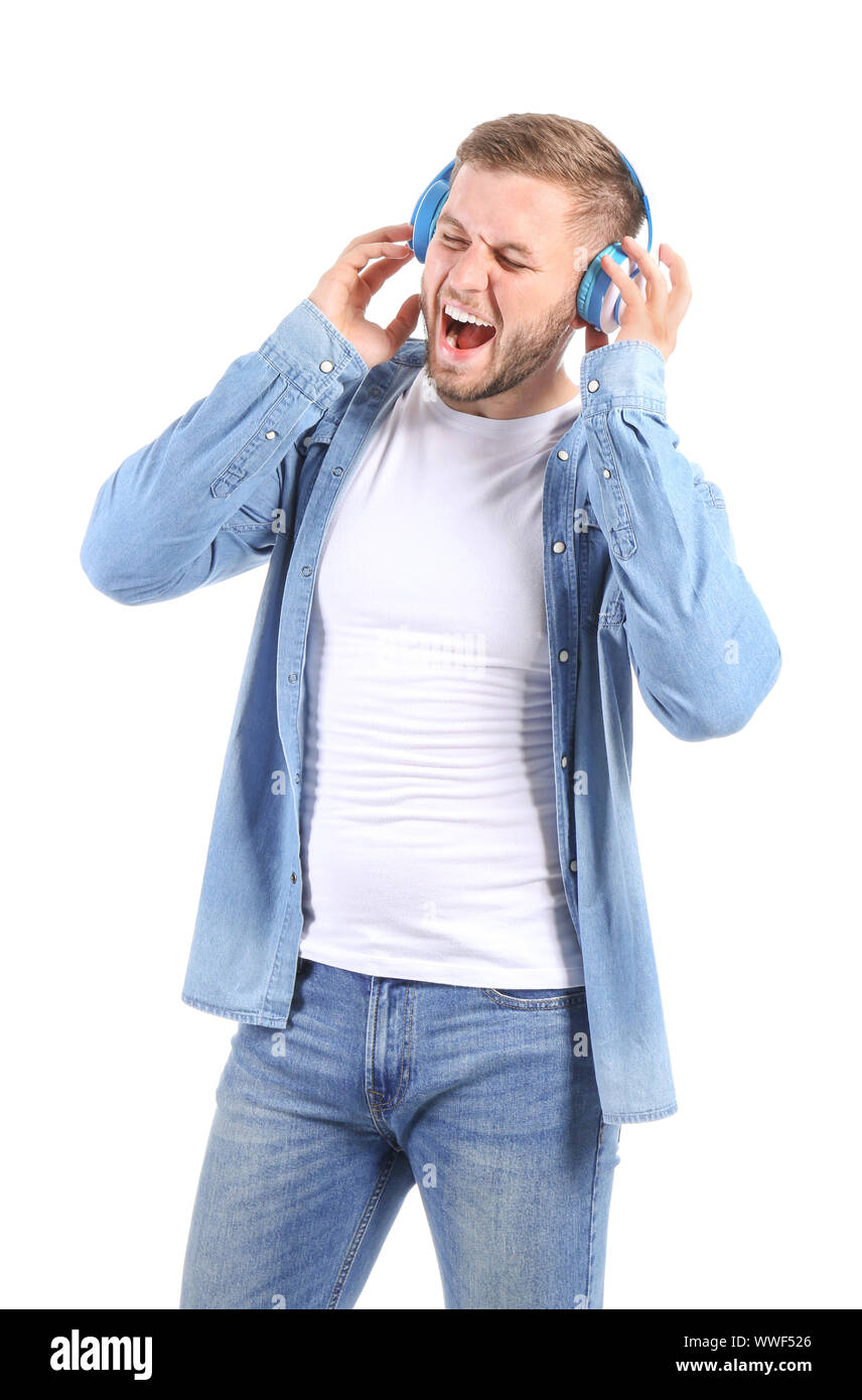 Handsome young man listening to music on white background Stock Photo ...