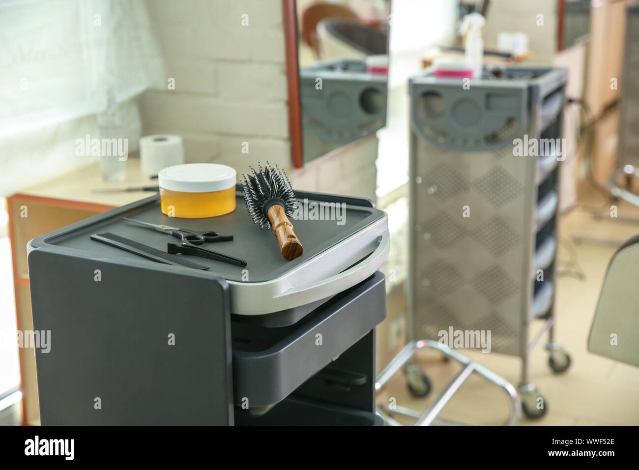 Tools and cosmetics on organizer in hairdressing salon Stock Photo - Alamy