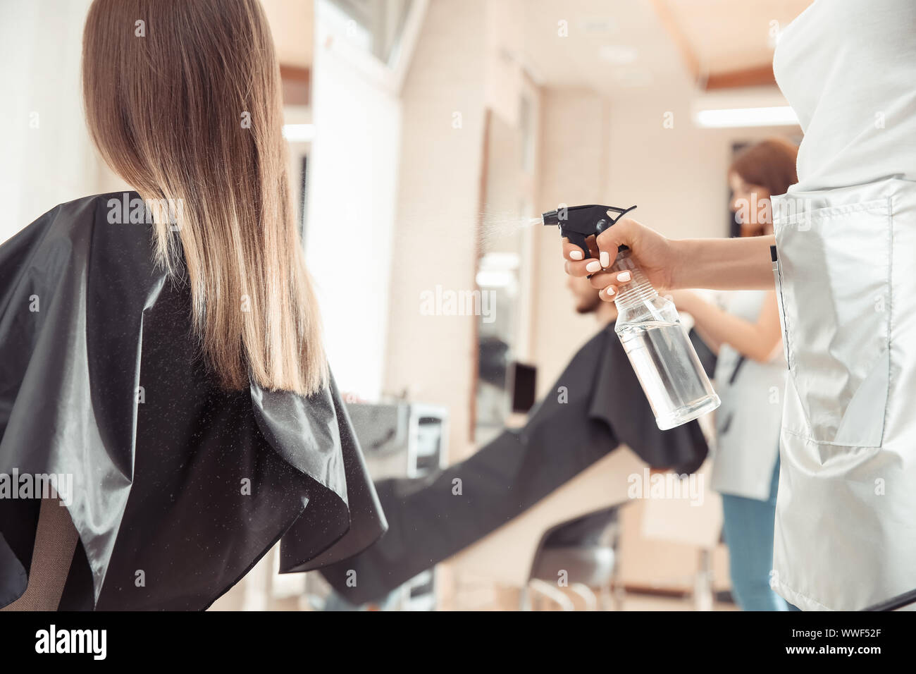 Female hairdresser working with client in salon Stock Photo - Alamy