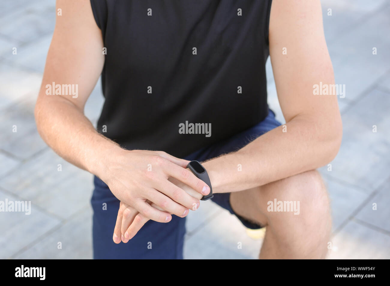 Sporty young man checking his pulse outdoors Stock Photo - Alamy