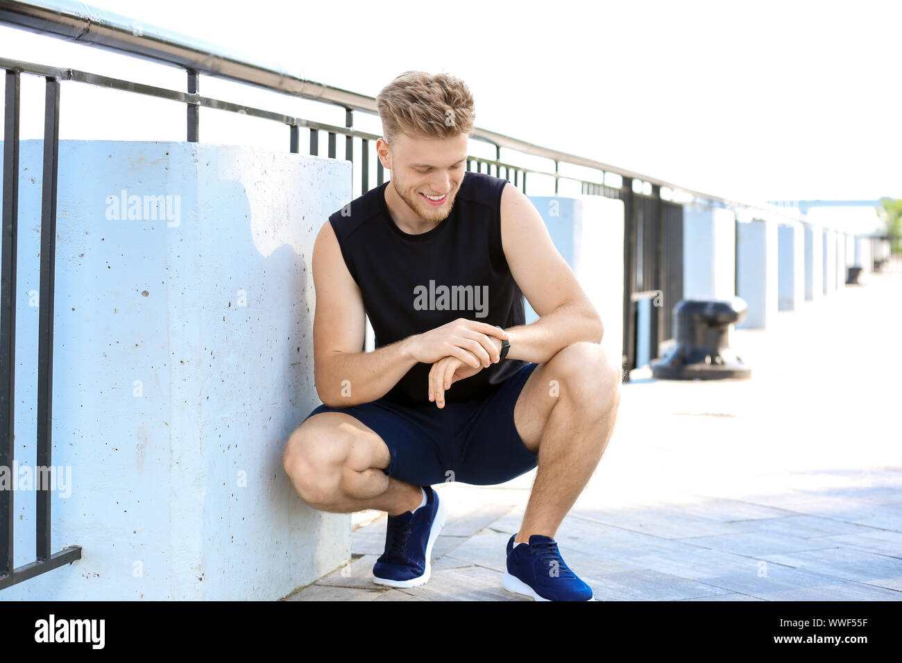 Sporty young man checking his pulse outdoors Stock Photo - Alamy