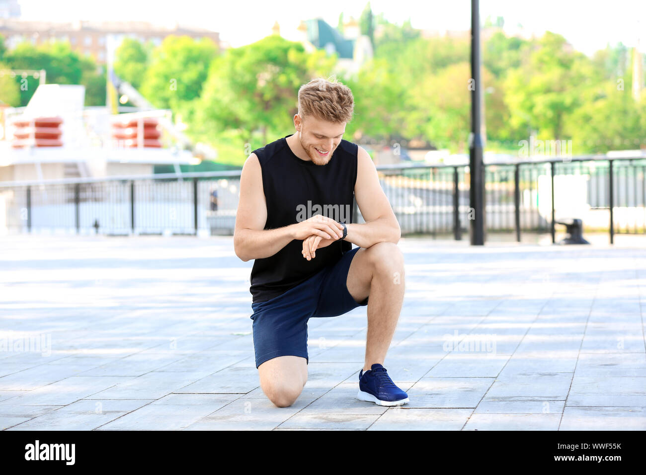 Sporty young man checking his pulse outdoors Stock Photo - Alamy