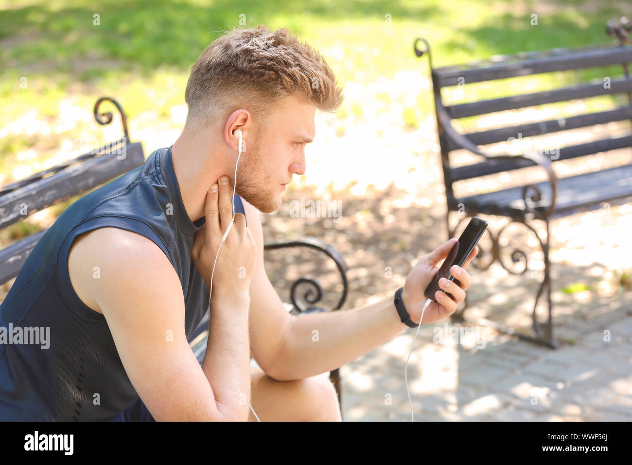 Sporty young man checking his pulse outdoors Stock Photo - Alamy