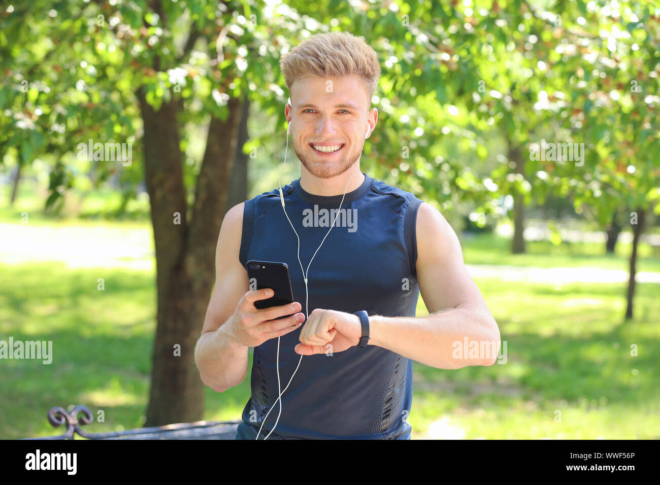Sporty young man checking his pulse outdoors Stock Photo - Alamy