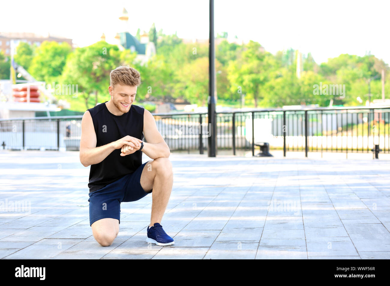 Sporty young man checking his pulse outdoors Stock Photo - Alamy