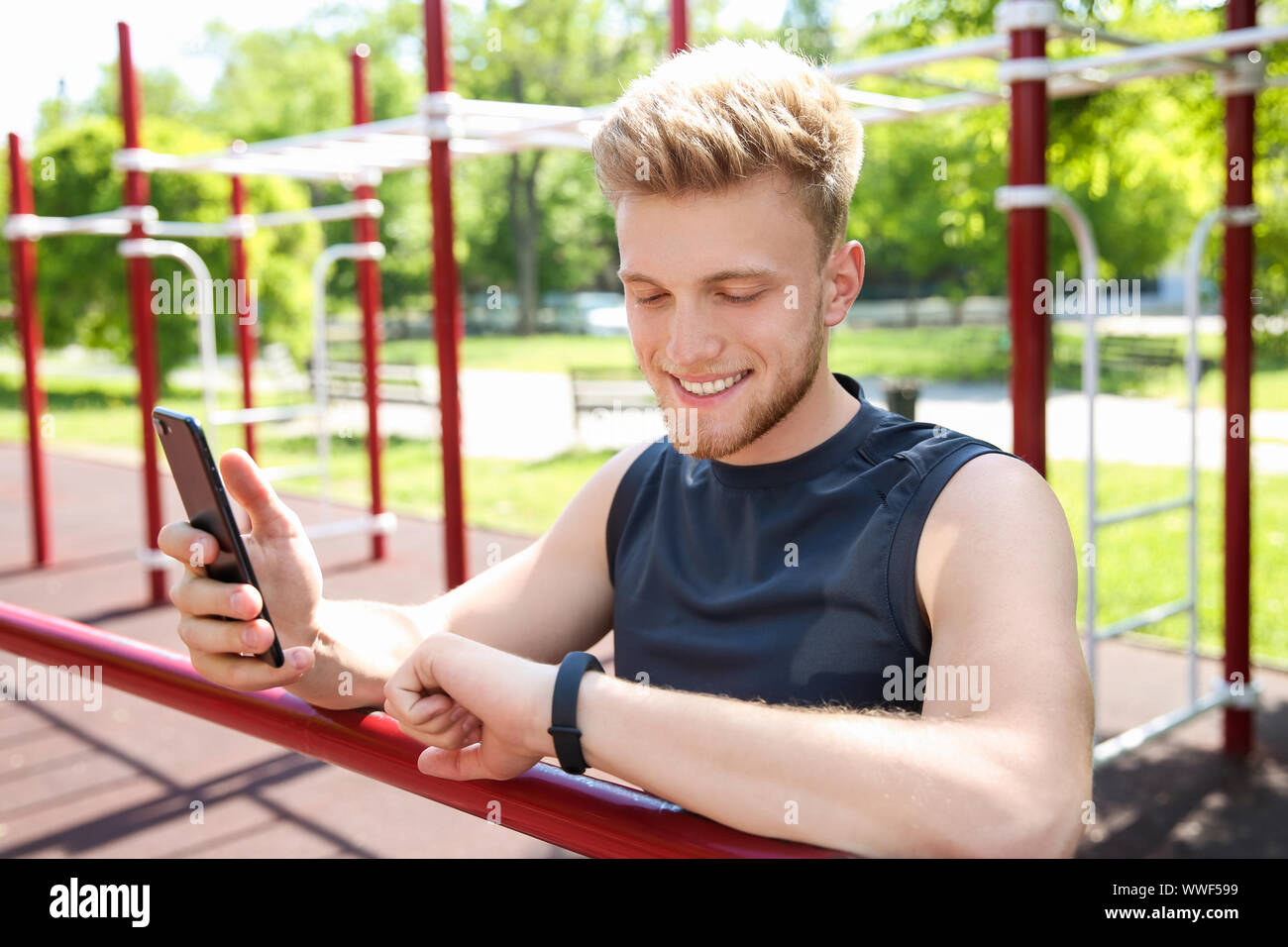 Sporty young man checking his pulse outdoors Stock Photo - Alamy