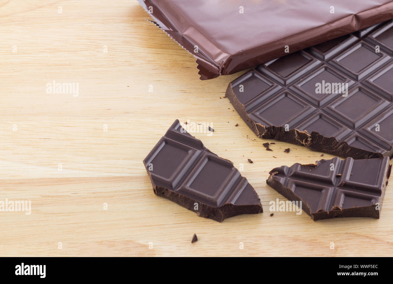 Picture of chocolate bar cracking on wooden background Stock Photo - Alamy