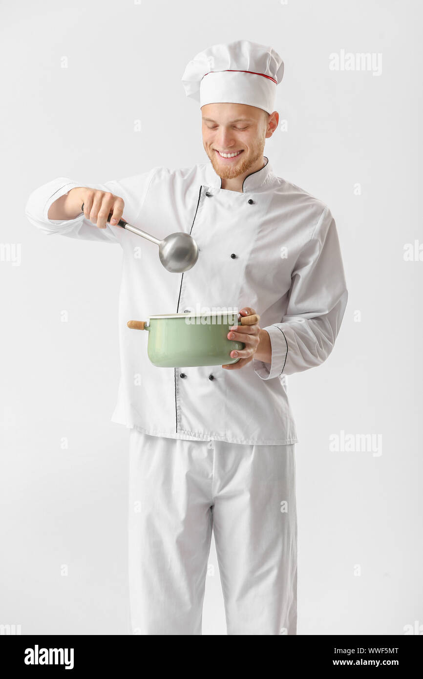 Handsome male chef with soup on white background Stock Photo - Alamy