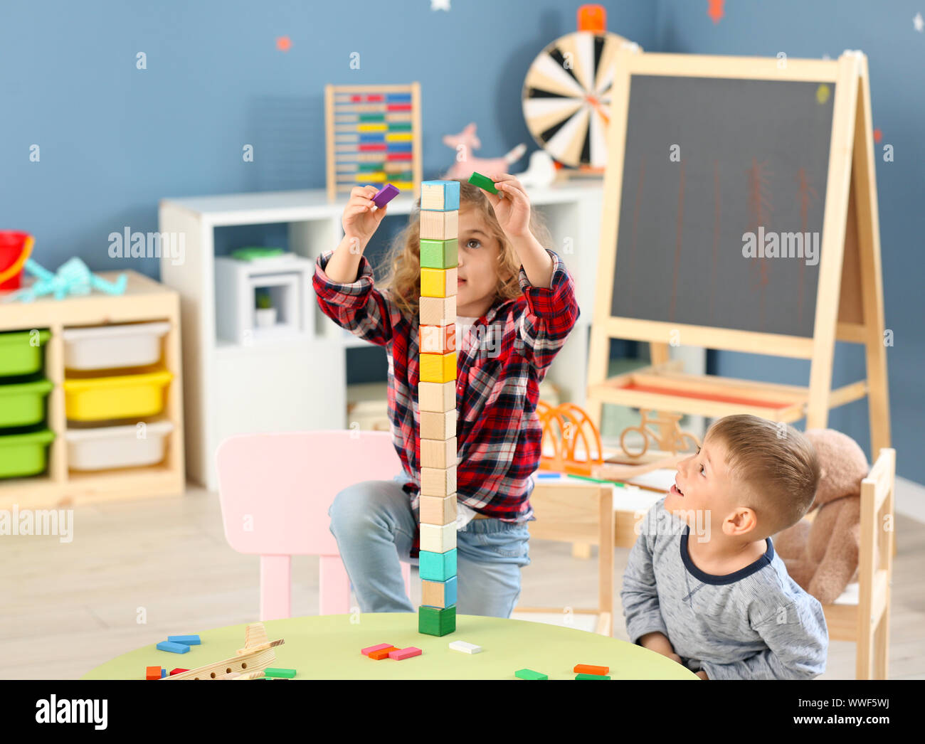 Cute little children playing in kindergarten Stock Photo - Alamy