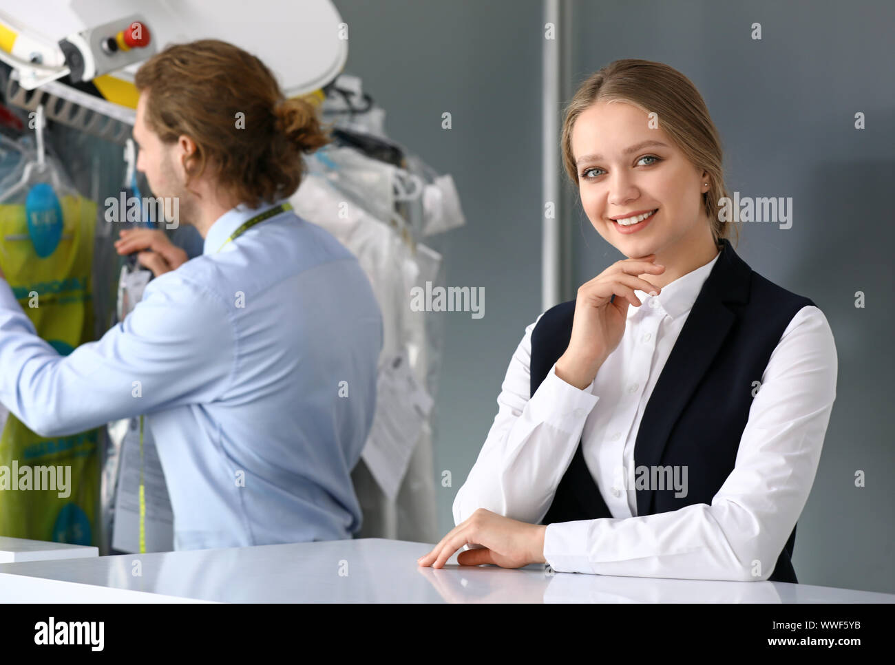 Workers of modern dry-cleaner's at reception Stock Photo - Alamy