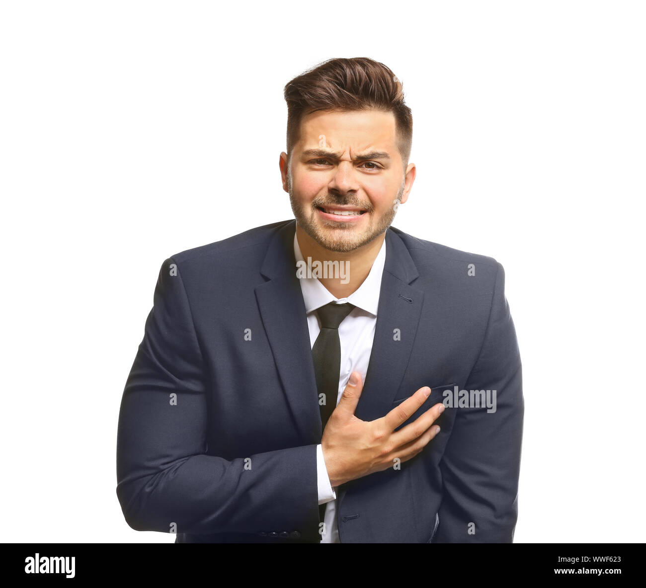Young businessman suffering from heart attack on white background Stock ...