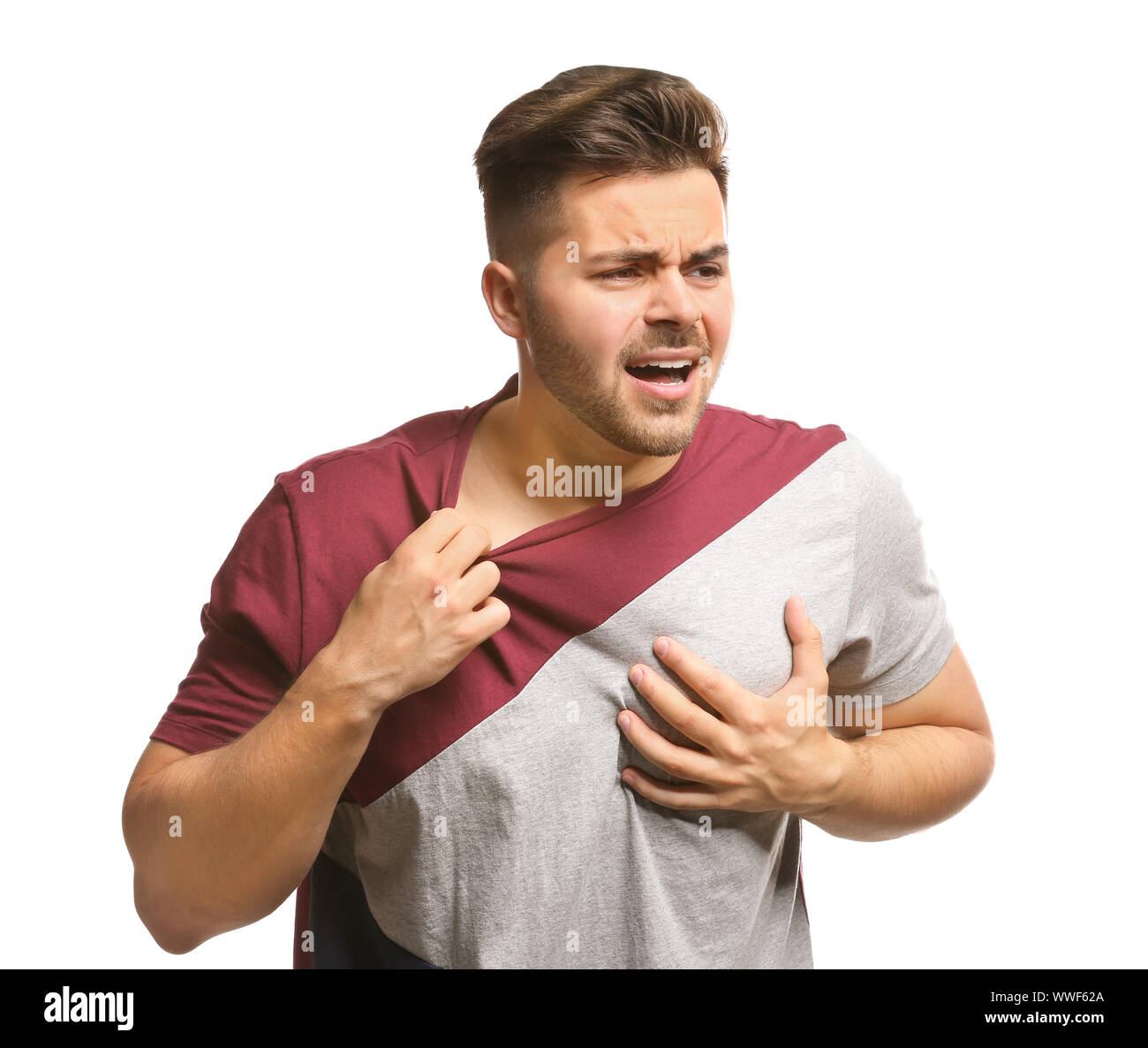 Young man suffering from heart attack on white background Stock Photo ...