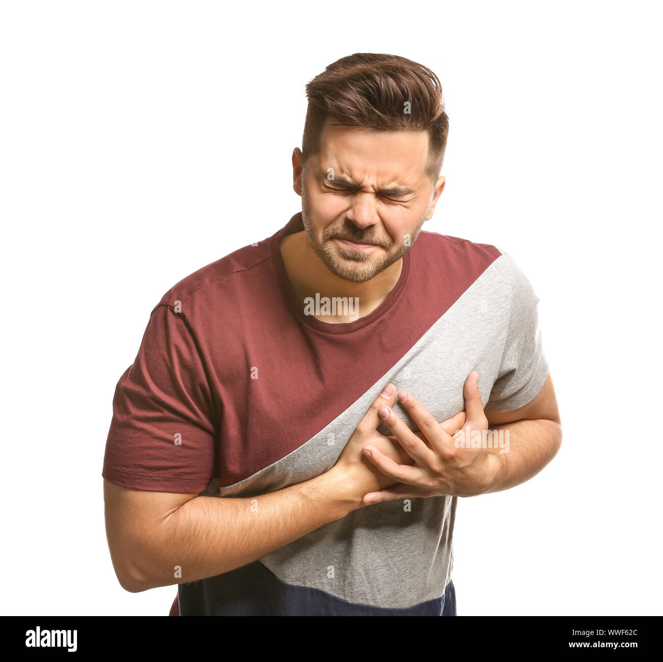 Young man suffering from heart attack on white background Stock Photo ...