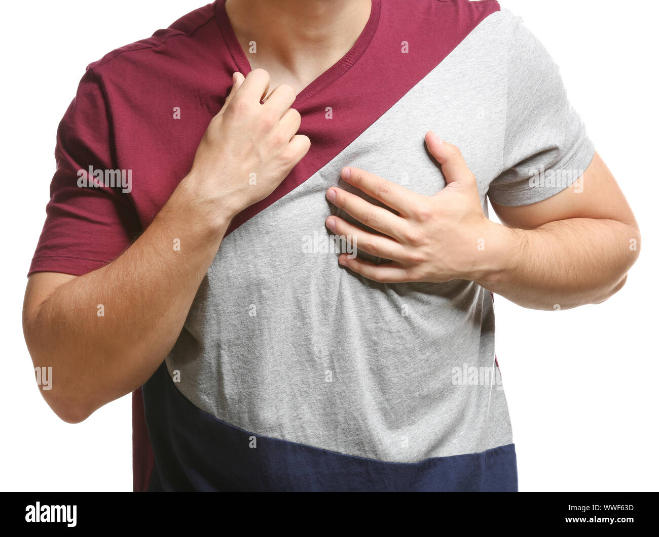 Young man suffering from heart attack on white background, closeup ...