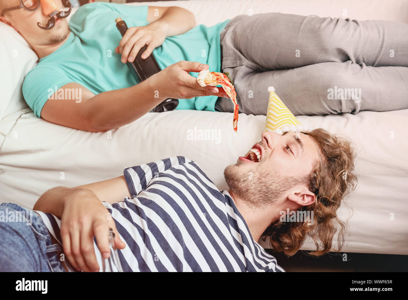 Drunk men after party at home Stock Photo - Alamy