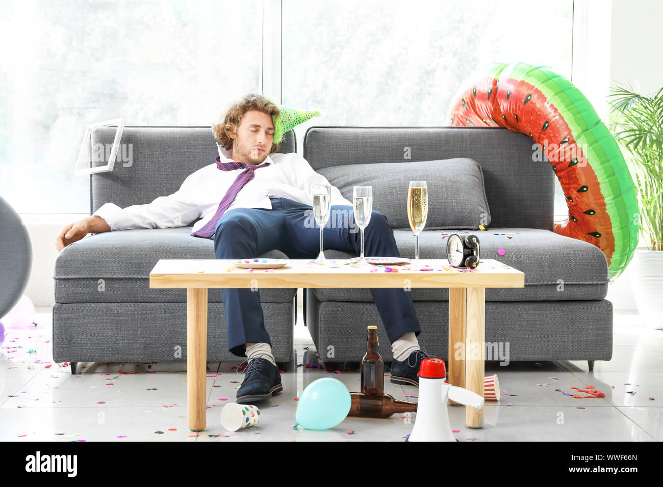 Young man sleeping after party at home Stock Photo - Alamy