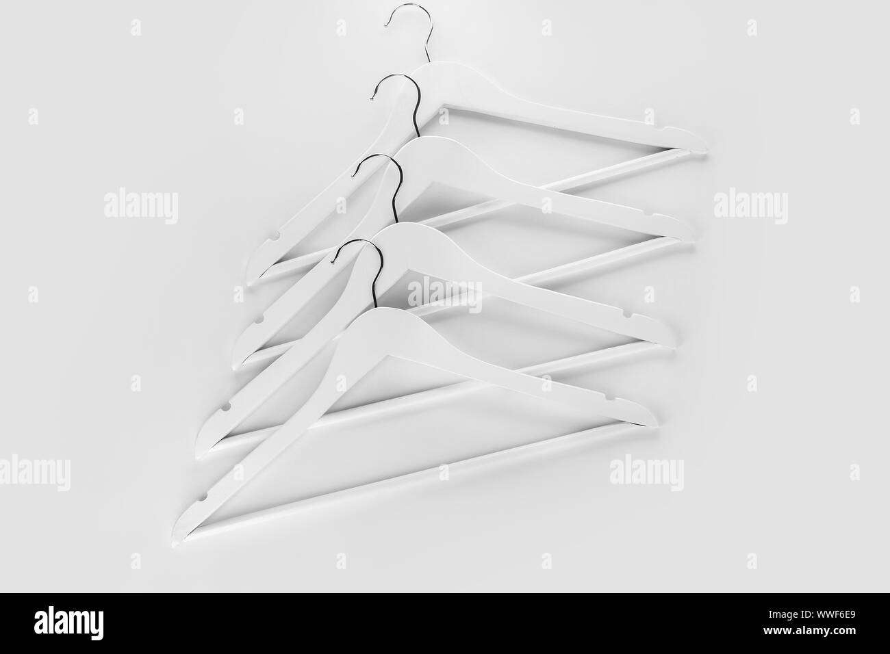Clothes hangers on white background Stock Photo - Alamy