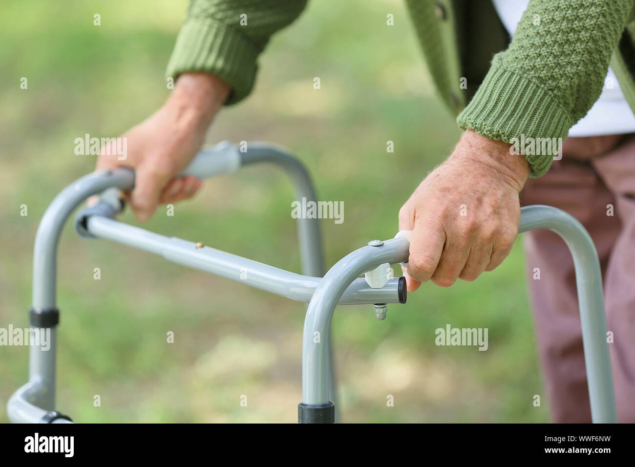 Elderly man with walking frame in park, closeup Stock Photo - Alamy