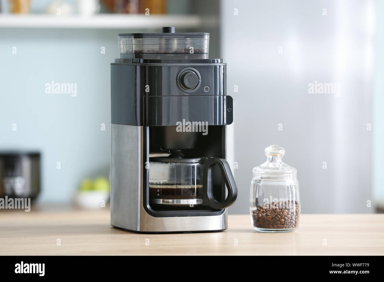 Modern coffee machine on table in kitchen Stock Photo - Alamy
