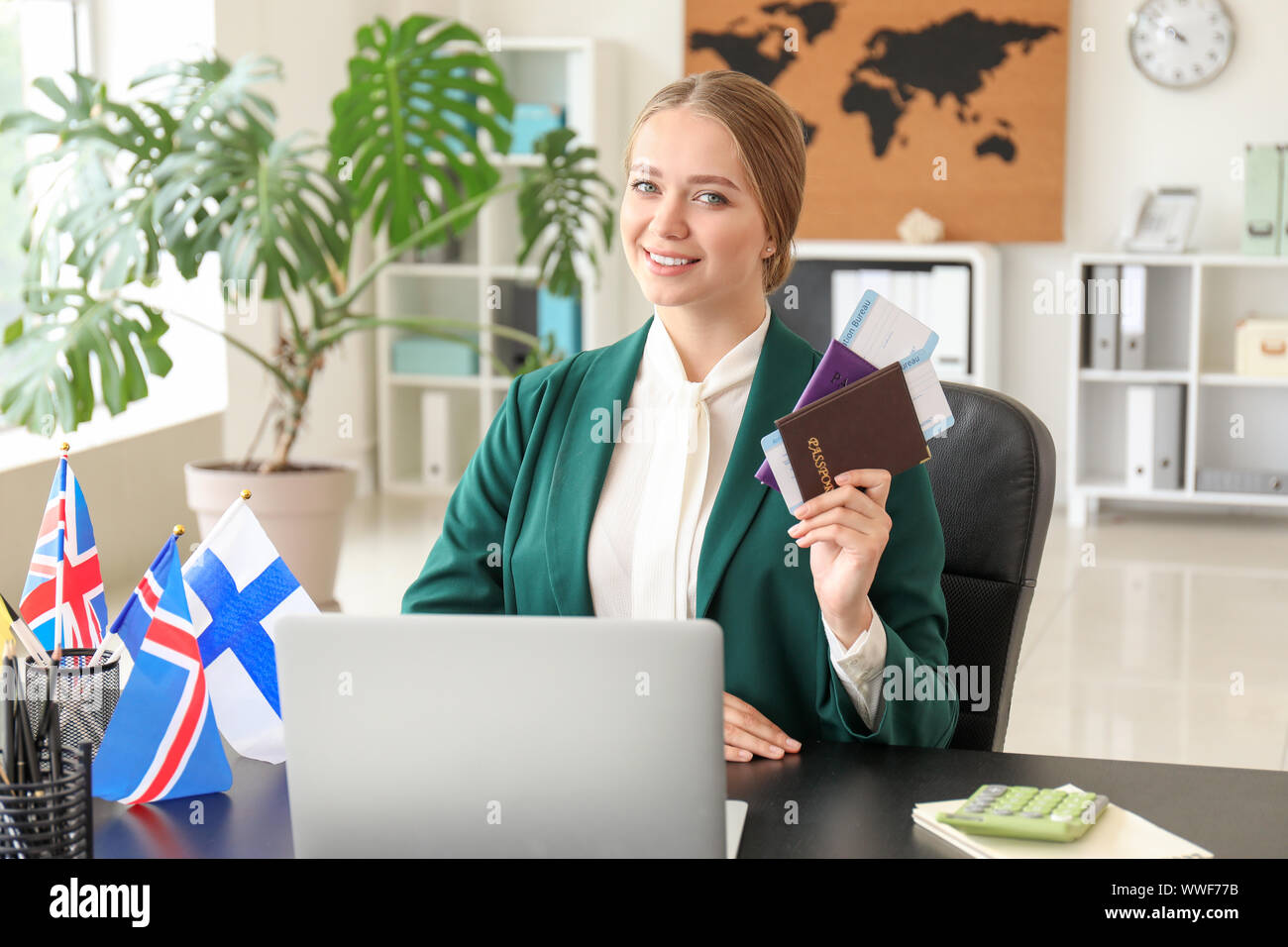 Female travel agent with passports and tickets in office Stock Photo ...