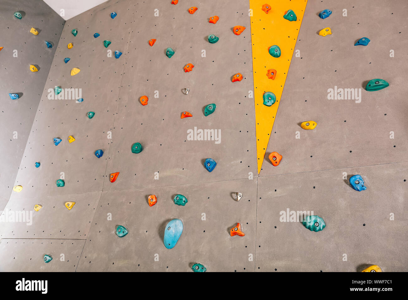 Wall with climbing holds in gym Stock Photo - Alamy
