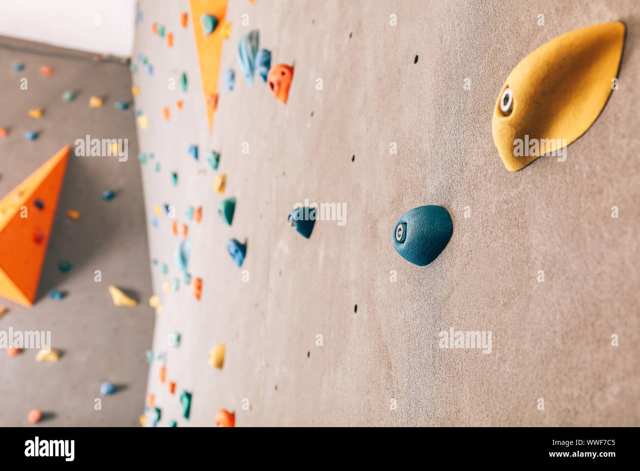 Wall with climbing holds in gym Stock Photo - Alamy