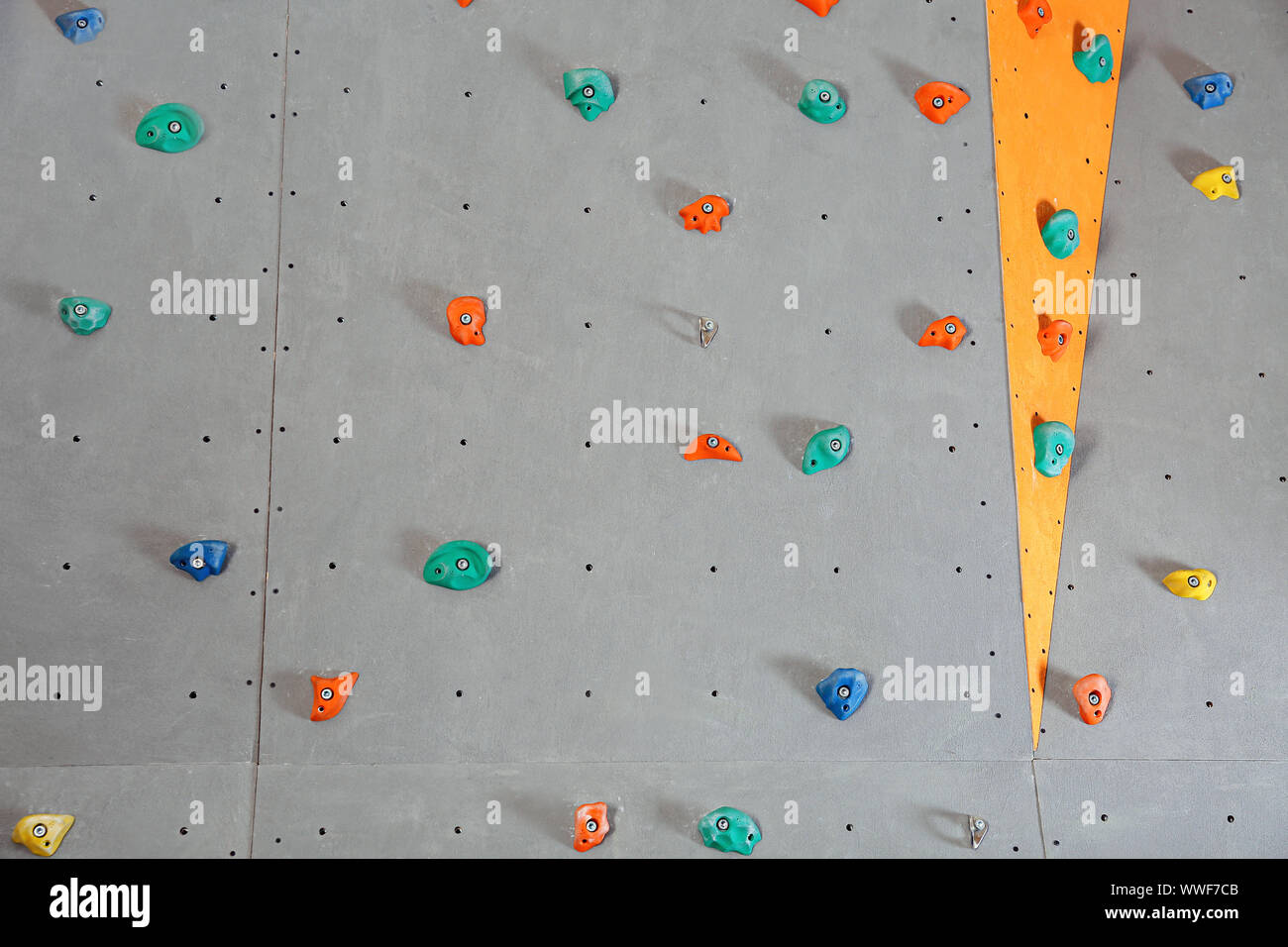 Wall with climbing holds in gym Stock Photo - Alamy