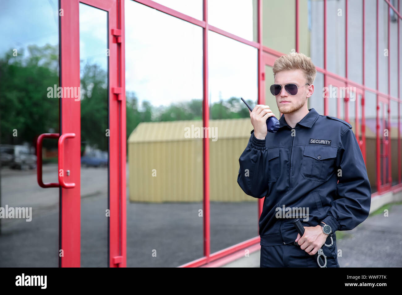 Handsome male security guard outdoors Stock Photo - Alamy