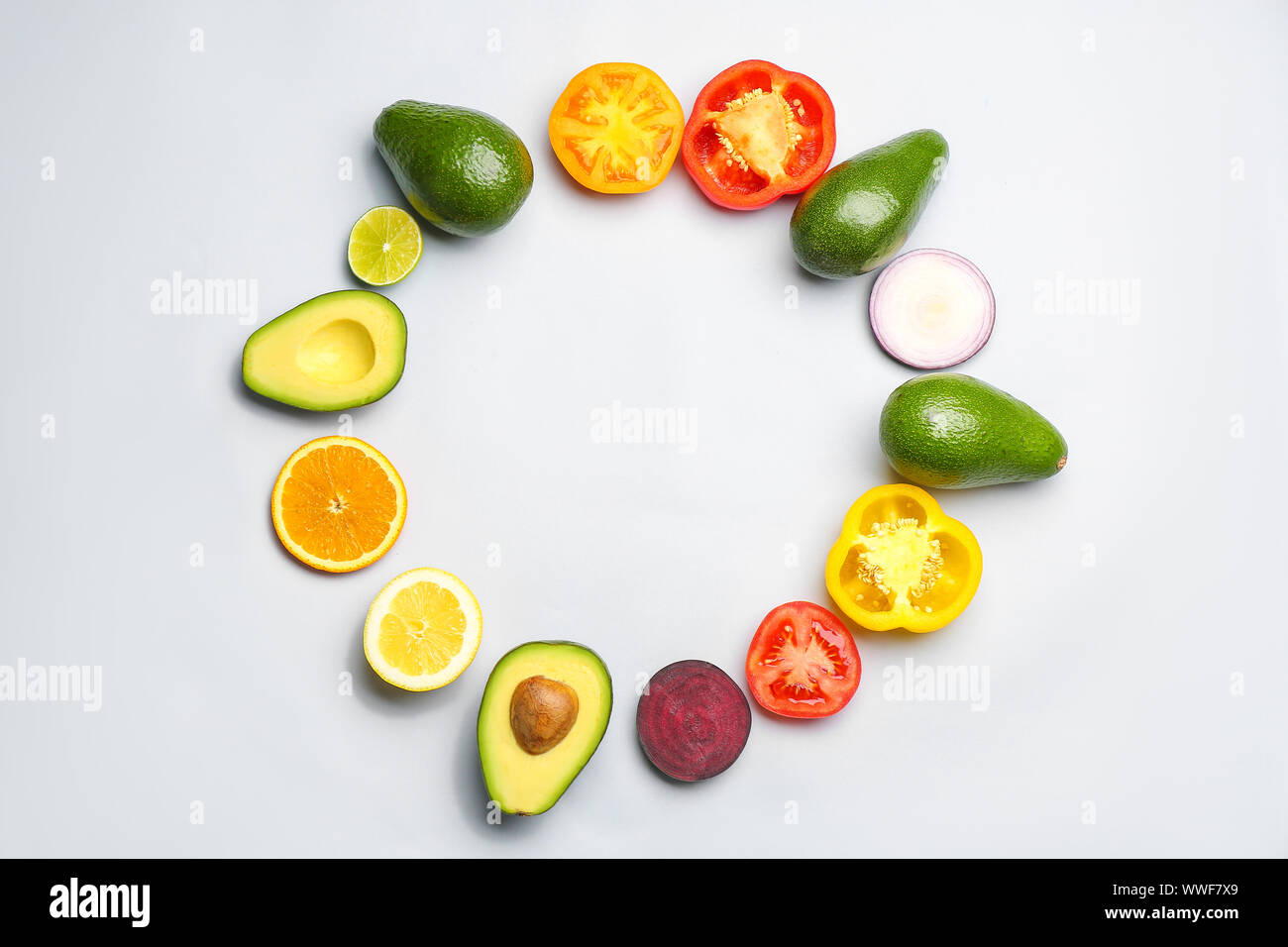 Frame made of avocado, fruits and vegetables on light background Stock ...
