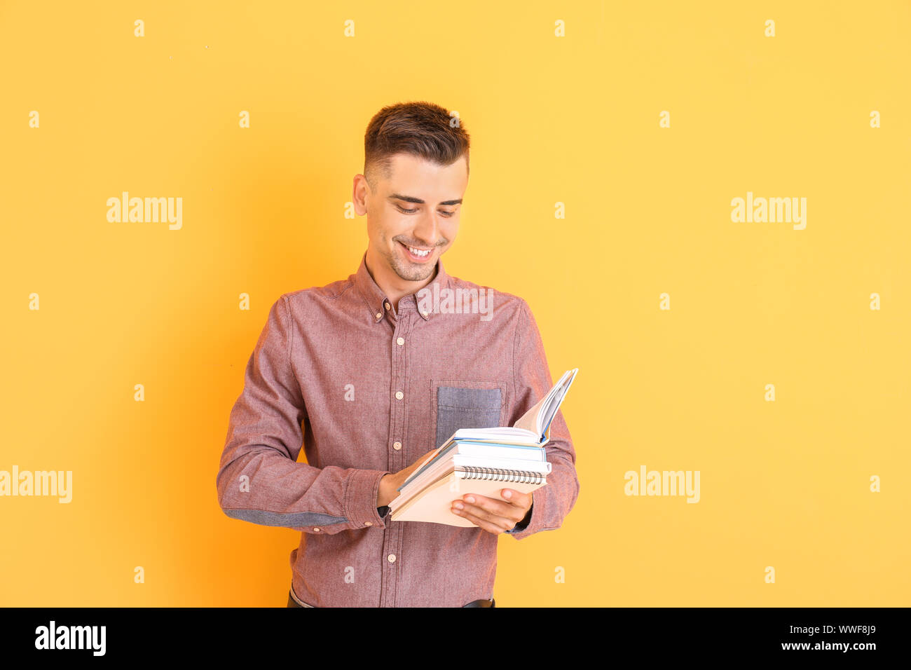 Handsome male teacher books hi-res stock photography and images - Alamy