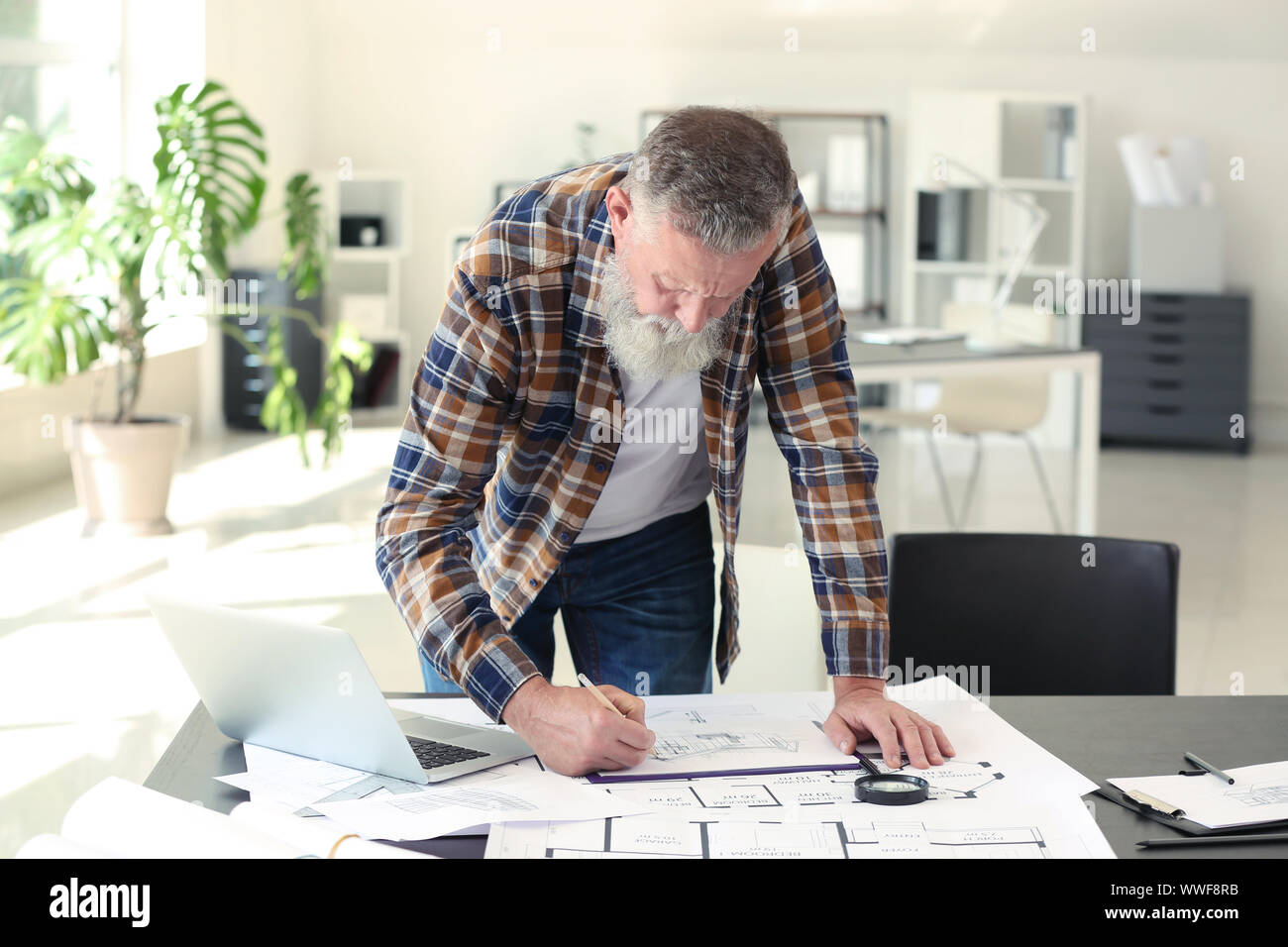 Mature male architect working in office Stock Photo - Alamy