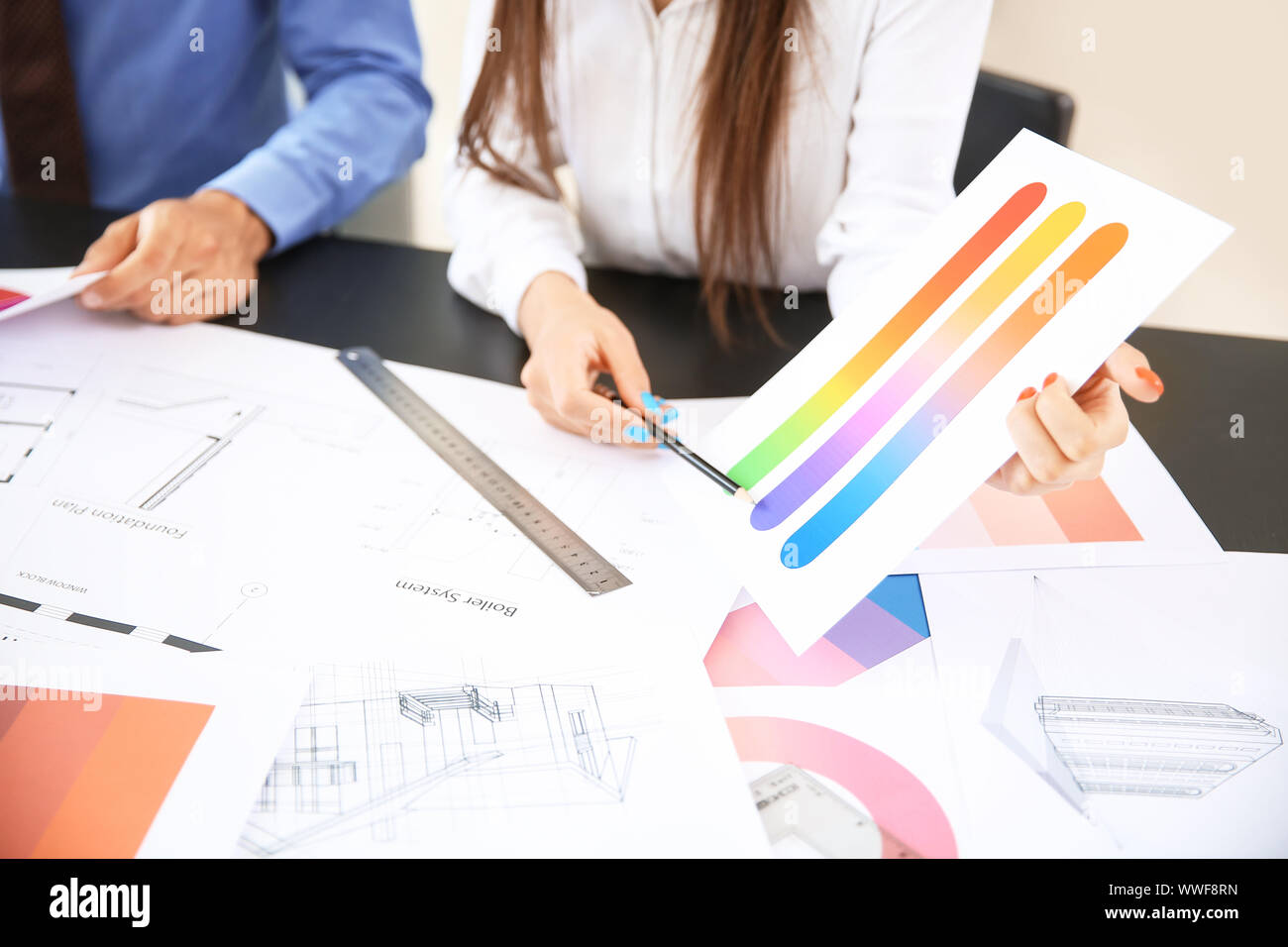 Team of architects discussing project in office Stock Photo - Alamy