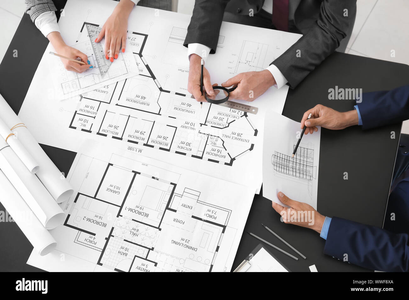 Team of architects discussing project in office Stock Photo - Alamy