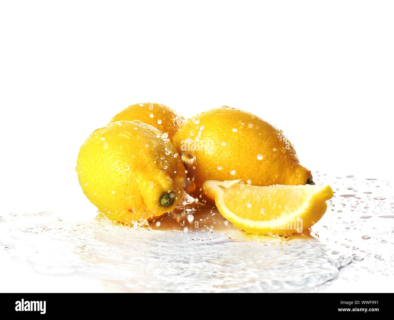 Ripe lemons with water splash on white background Stock Photo - Alamy