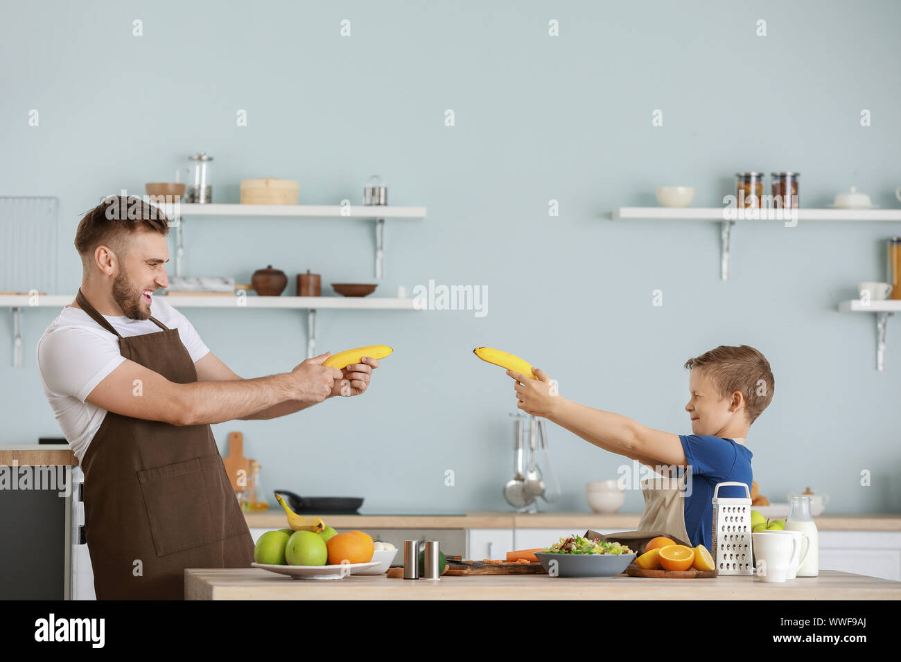 Portrait of father and son having fun while cooking in kitchen Stock ...