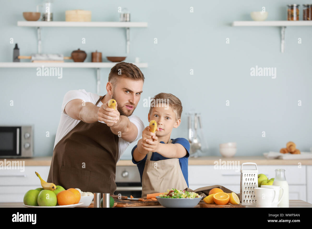Portrait of father and son having fun while cooking in kitchen Stock ...