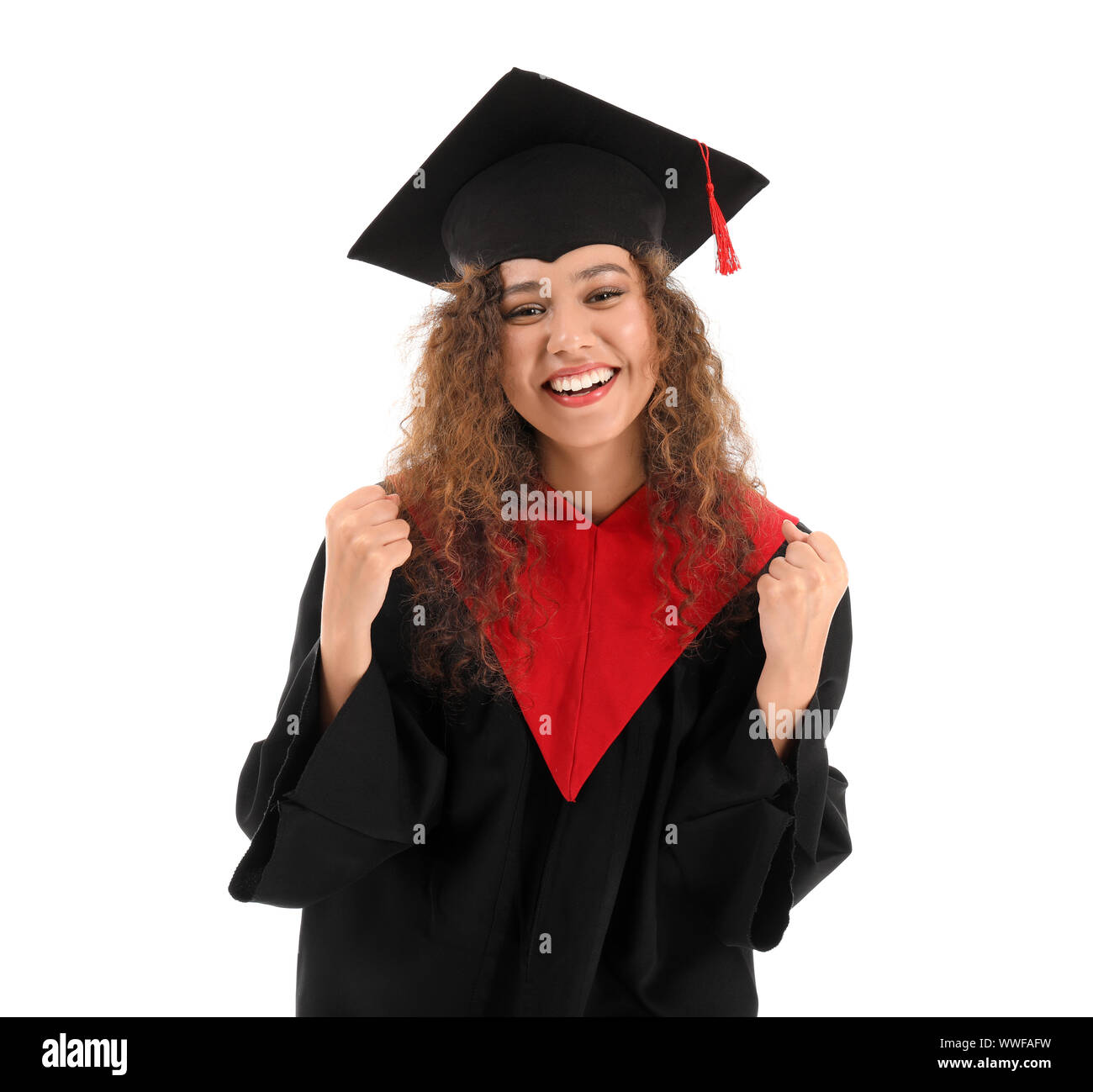 Young African-American student in bachelor robe on white background ...