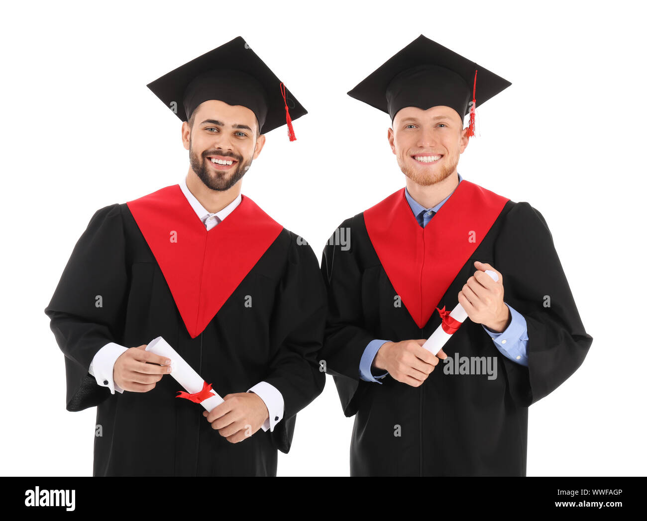 Young students in bachelor robes on white background Stock Photo - Alamy