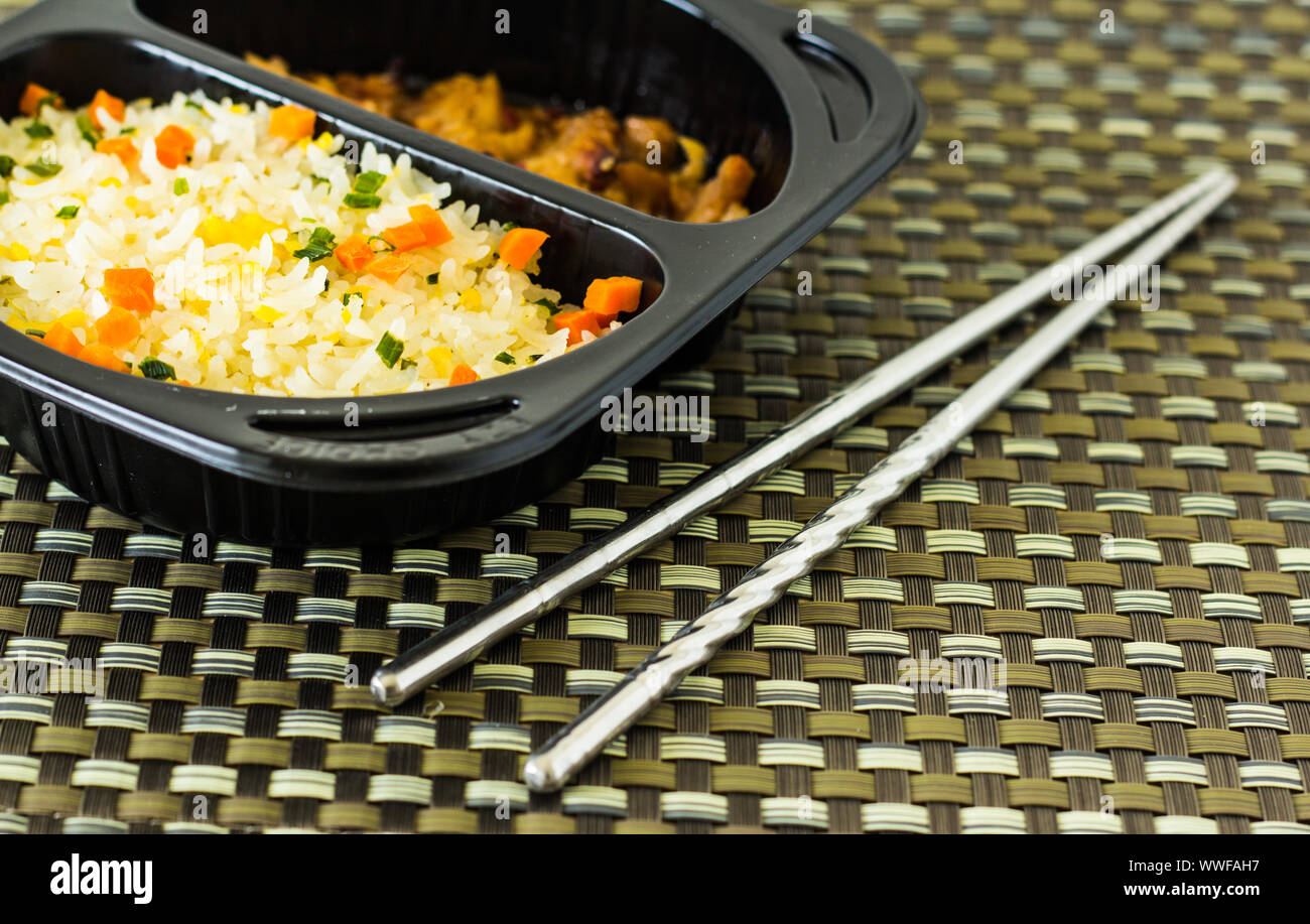 Fire rice in a black lunch box with chopsticks Stock Photo - Alamy