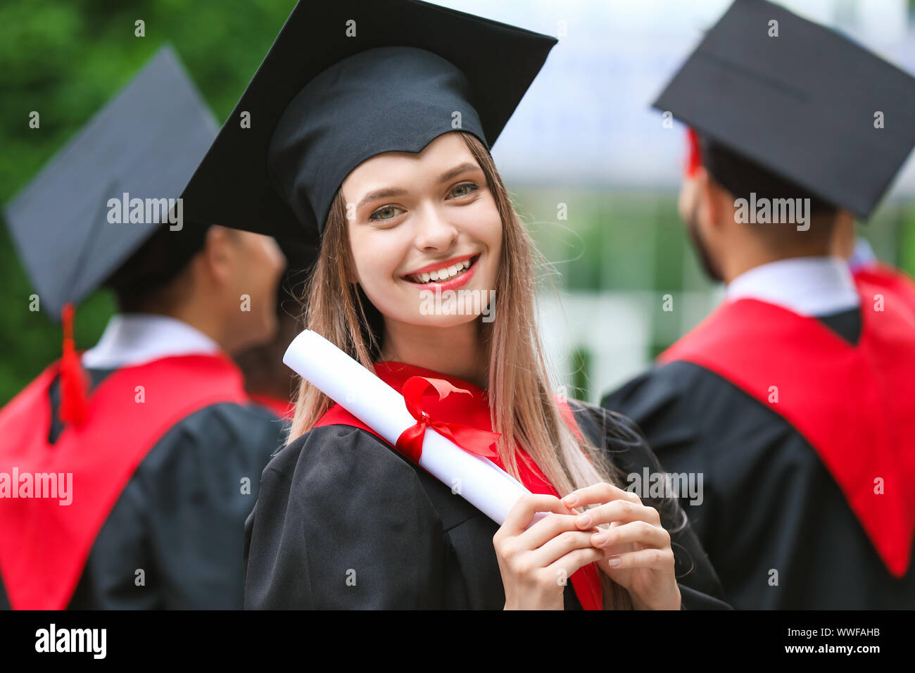 Female student in bachelor robe and with diploma outdoors Stock Photo ...