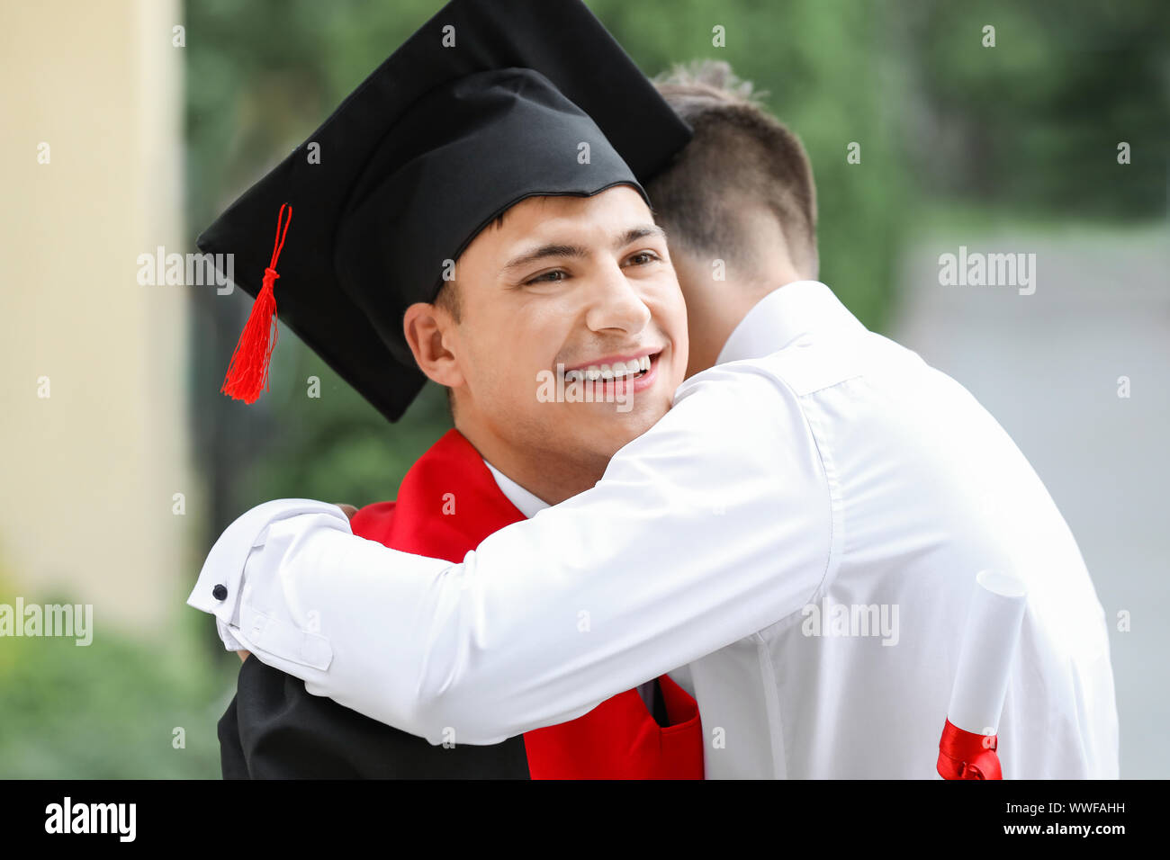 Professor greeting young student on his graduation day Stock Photo - Alamy