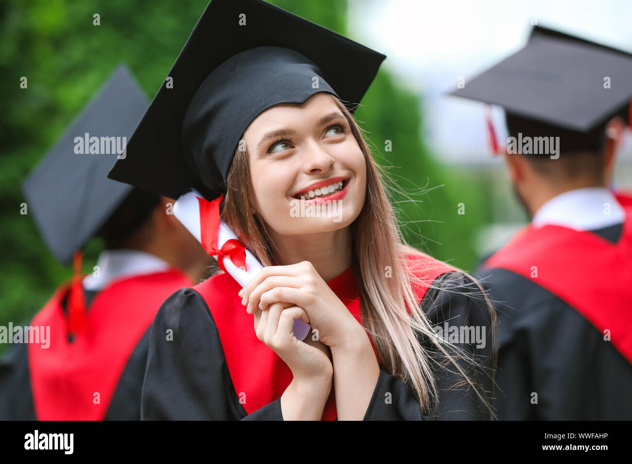Female student in bachelor robe and with diploma outdoors Stock Photo ...
