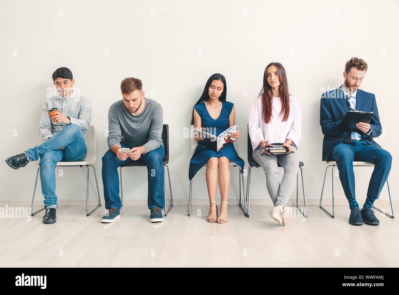 Young people waiting for job interview indoors Stock Photo - Alamy