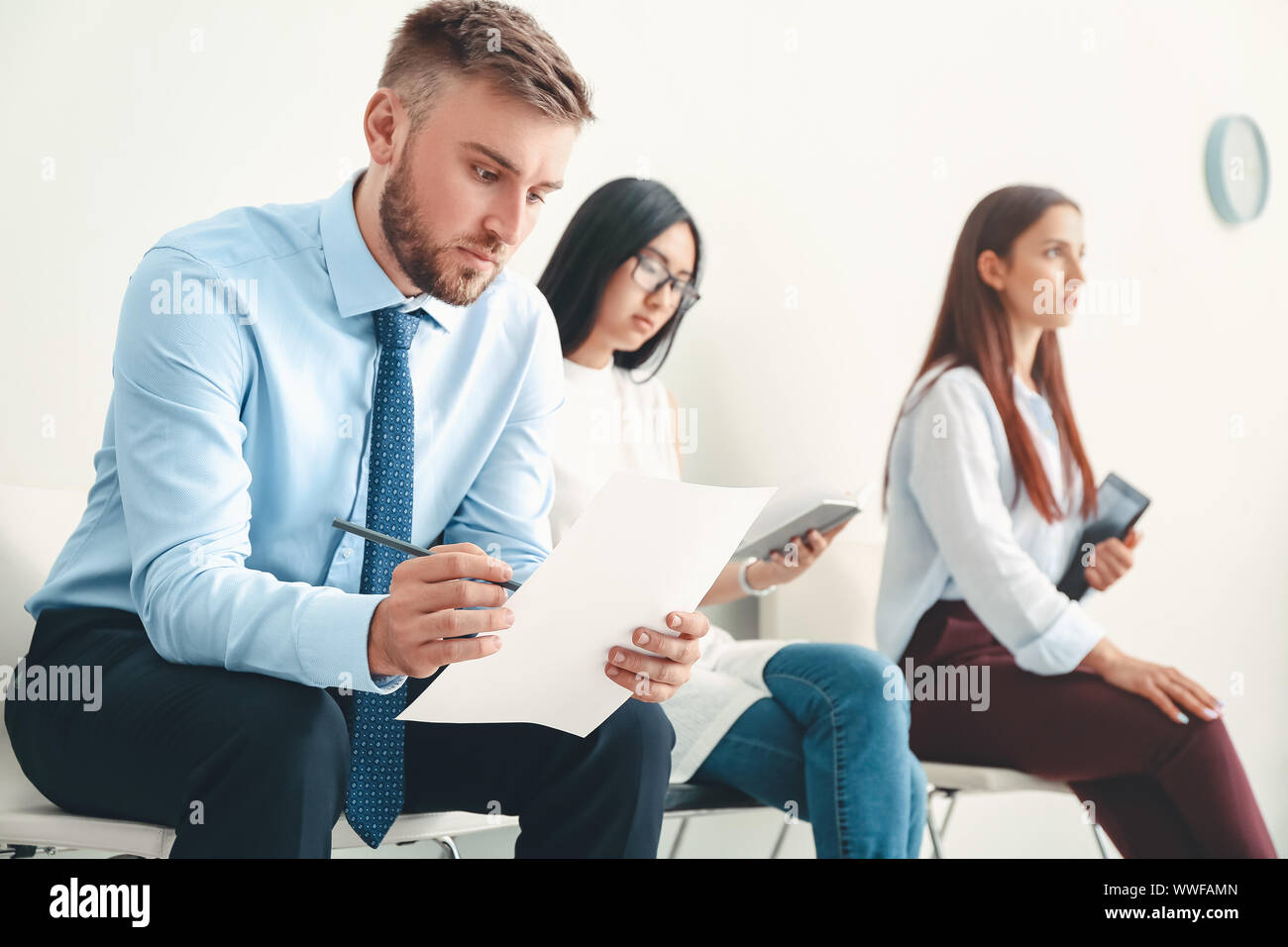 Young people waiting for job interview indoors Stock Photo - Alamy